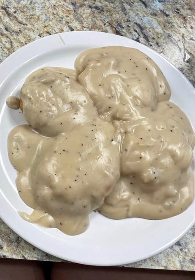 These biscuits and gravy aren't just a meal—they're a masterpiece of Southern comfort that makes you want to hug the chef and steal the recipe.