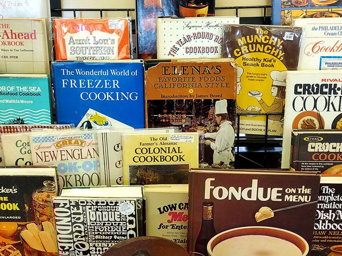 Cookbooks from another era line these shelves—each one a time capsule of when fondue was fancy and Jell-O was haute cuisine.