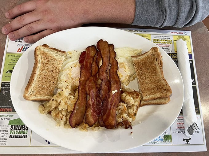 Breakfast perfection doesn't need fancy plating—just perfectly crisp bacon, fluffy eggs, and toast that hits that golden-brown sweet spot.