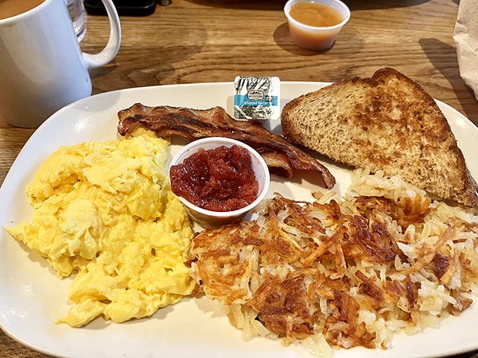 Breakfast perfection doesn't need fancy frills—just fluffy scrambled eggs, crispy hash browns, and bacon that makes you question all other bacon you've ever known.
