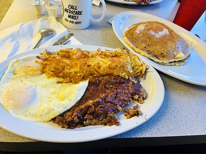Behold the holy trinity of breakfast: perfectly sunny eggs, crispy hash browns, and what appears to be corned beef hash. The breakfast gods are smiling.