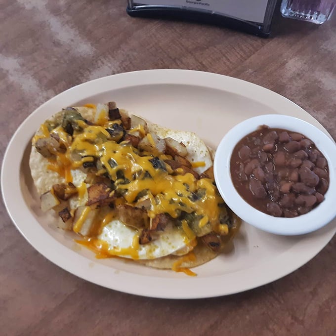Breakfast nirvana: eggs smothered in cheese and potatoes with a side of pintos. In Texas, this is what they mean by "balanced diet."