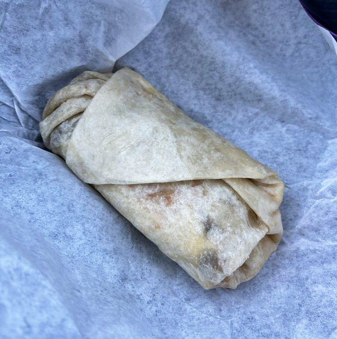 The legendary breakfast burrito in its natural habitat – perfectly wrapped, slightly toasted, and ready to cure whatever ails you.