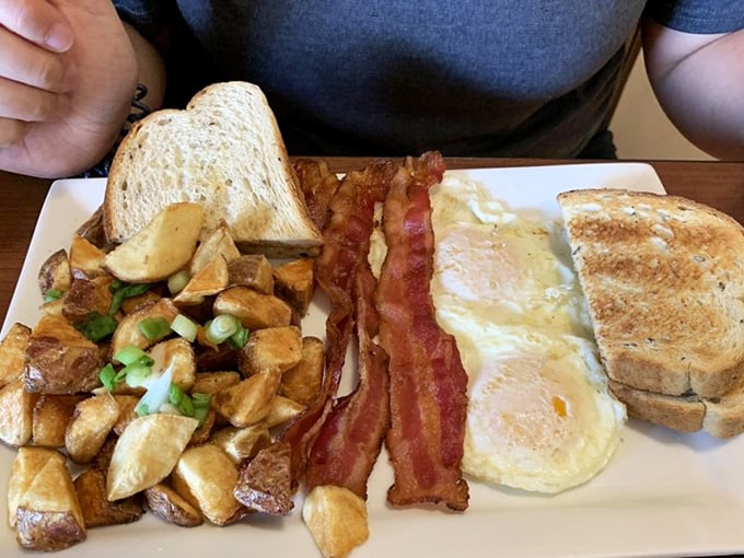 Breakfast perfection on a plate – those home fries are the supporting actors that steal the show from the eggs and bacon.
