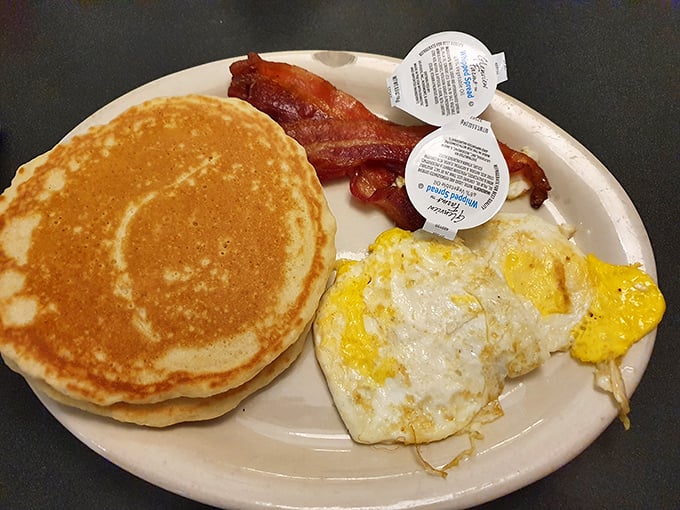 Golden pancake perfection meets crispy bacon and sunny-side-up eggs—the holy trinity of breakfast done right.