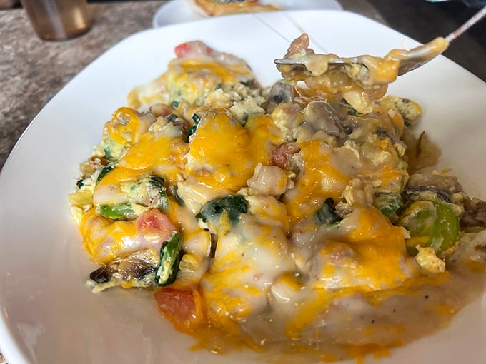 Behold the legendary breakfast skillet—a glorious mountain of eggs, veggies, and cheese that's worth setting your alarm for.