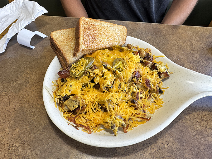 Behold the breakfast skillet—a glorious mountain of cheese-capped ingredients that makes Monday mornings bearable again. Worth setting an alarm for.