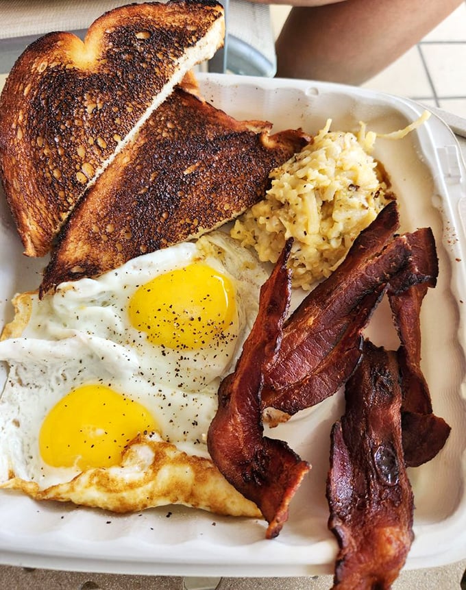 Breakfast perfection doesn't need fancy plating—just perfectly cooked eggs, crispy bacon, and hashbrowns that make you want to high-five the cook.