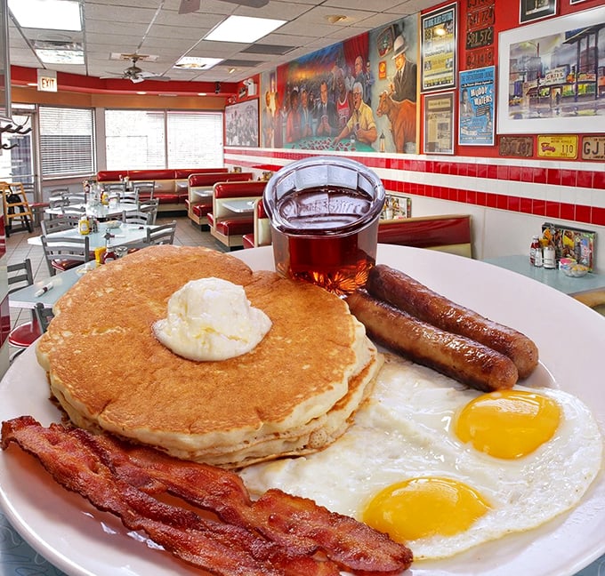 Breakfast perfection on a plate – golden pancakes, sunny eggs, and bacon that's achieved that mythical balance between crispy and chewy.