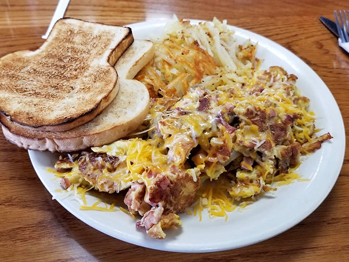 This isn't just breakfast—it's a masterpiece of morning indulgence with perfectly scrambled eggs, crispy hash browns, and toast that's achieved golden perfection.