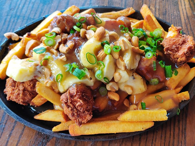 Breakfast poutine that would make Canadians jealous – golden fries, savory gravy, melty cheese curds, and what appears to be fried chicken. Morning glory!