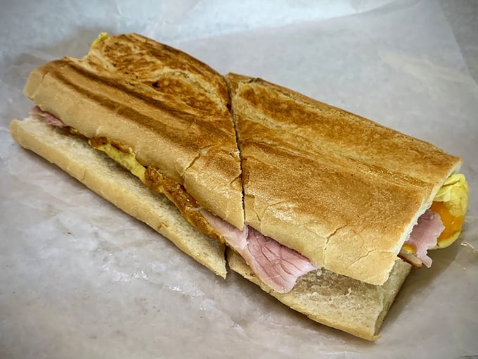 This isn't just breakfast—it's edible architecture where crispy Cuban bread cradles layers of ham and egg in perfect harmony.