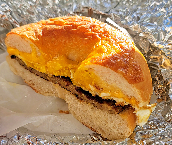 This breakfast sandwich isn't just food—it's morning salvation wrapped in foil, with melted cheese cascading over perfectly seasoned meat.