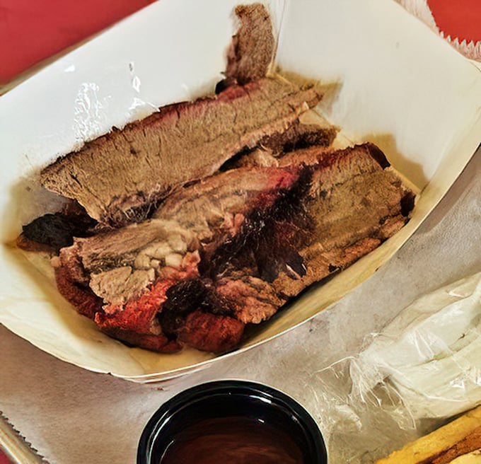 Behold the holy grail of smoked meats—brisket with that telltale pink smoke ring that whispers, "I've been loved for hours." No Instagram filter needed.