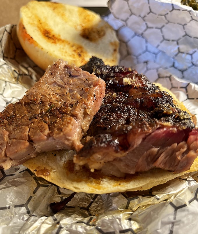 This isn't just a brisket sandwich – it's a masterclass in smoke and patience, with that perfect pink ring that makes barbecue aficionados weak in the knees.