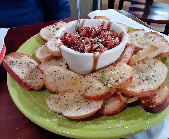 Behold the bruschetta that launched a thousand road trips – fresh tomatoes dancing on perfectly toasted bread.