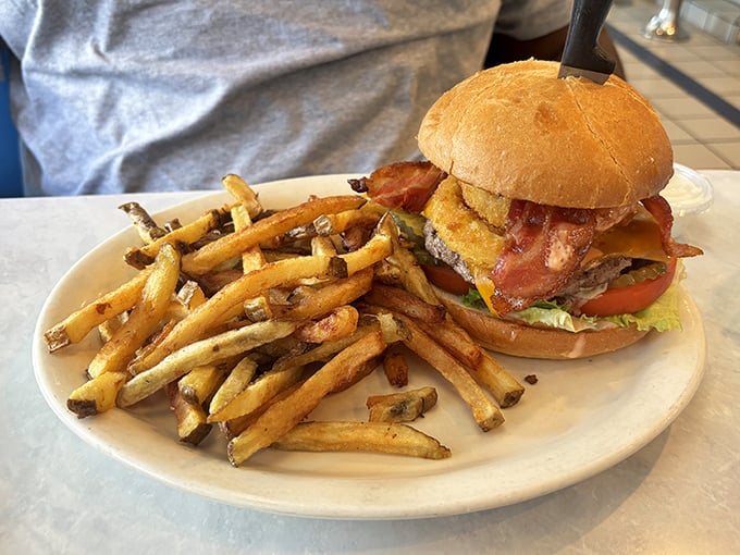 Behold the burger that launched a thousand food pilgrimages—perfectly charred, generously topped, and flanked by hand-cut fries that demand respect.