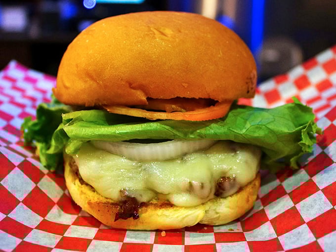 This isn't just a burger—it's edible architecture. Melted cheese cascades over perfectly seared beef like a dairy waterfall.