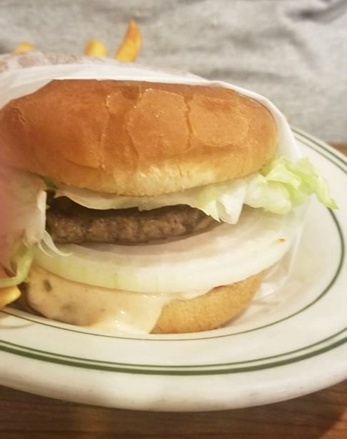 Behold, burger perfection in its purest form—no pretentious toppings or artisanal nonsense, just the harmonious marriage of beef, cheese, and fresh vegetables.