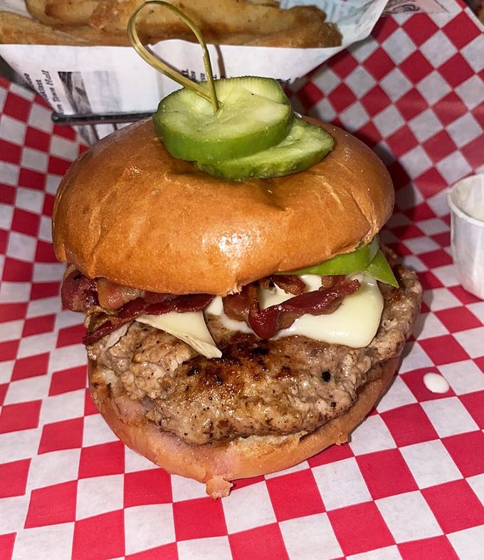 This isn't just a burger – it's architecture. Note the strategic pickle placement and the perfect cheese-to-bacon ratio.