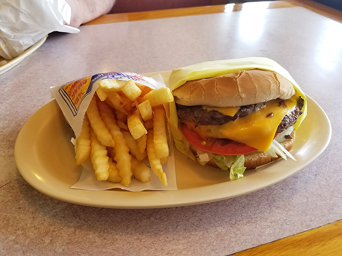 This isn't just a cheeseburger—it's edible poetry on a plate, with melted cheese cascading over a substantial patty.