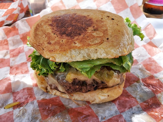 This isn't just a burger—it's edible architecture, a perfectly balanced tower of beef, cheese, and fresh veggies that demands both hands and your full attention.