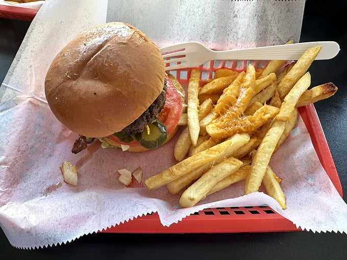 This isn't just a burger, it's edible architecture – a hand-formed patty on a toasted bun with fries that deserve their own fan club.