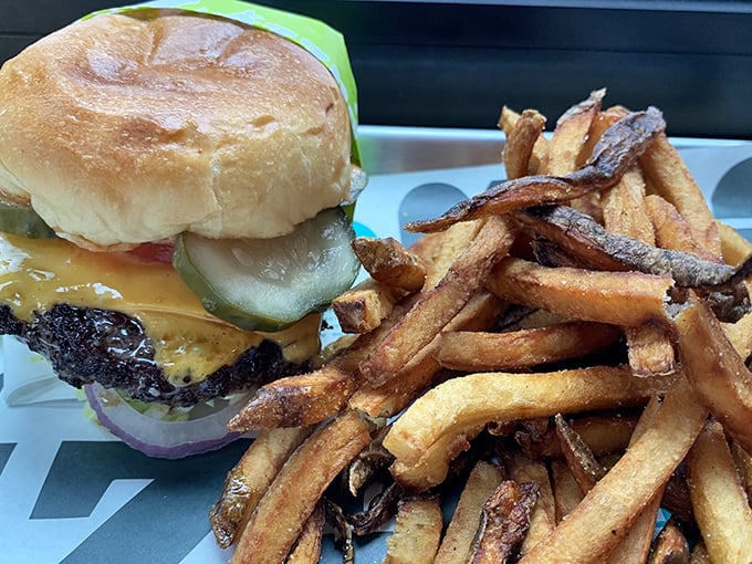 This isn't just a burger and fries – it's edible architecture. The golden ratio of beef to cheese to pickle, with fries that deserve their own fan club.