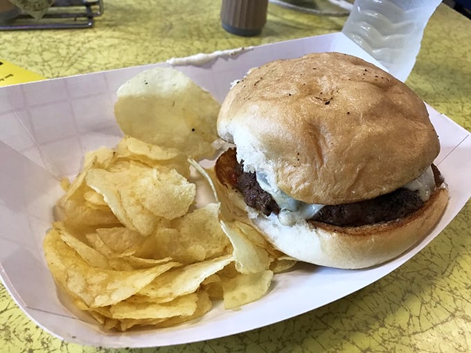 This burger doesn't need fancy aioli or artisanal buns to be magnificent – just a perfectly seasoned patty, fresh toppings, and chips that crackle with each bite.