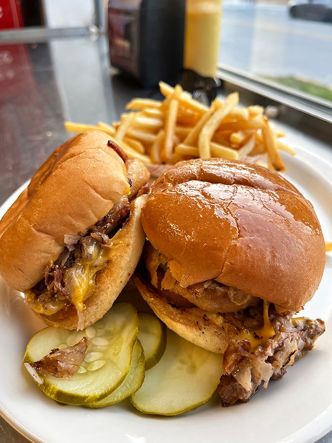 Behold the stars of the show—sliders with perfectly caramelized onions melting into the patty, a burger experience that defies their humble size.