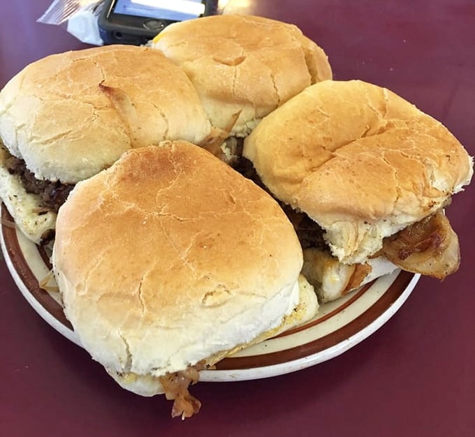 Four perfect sliders on a plate—like a barbershop quartet of beef, each one harmonizing with grilled onions and pillowy buns.