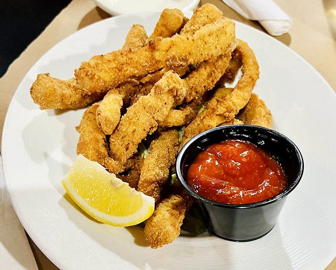 These golden calamari fingers aren't just fried – they're transformed into crispy treasures that would make even coastal snobs nod in approval.