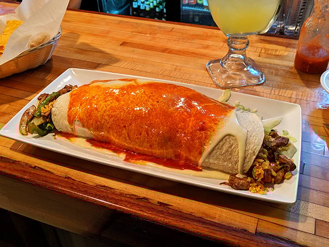 This isn't just a burrito—it's an architectural marvel wrapped in a tortilla, with sauce cascading down its sides like delicious lava from a flavor volcano.