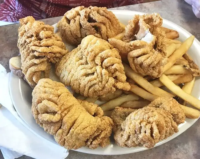 Golden-fried catfish that looks like it's wearing a cornmeal crown – crispy, crunchy, and practically begging to be dunked in tartar sauce.