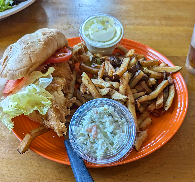 This catfish sandwich isn't just food—it's an event. Crispy fish, fresh toppings, and those hand-cut fries could make a pescatarian weep with joy.