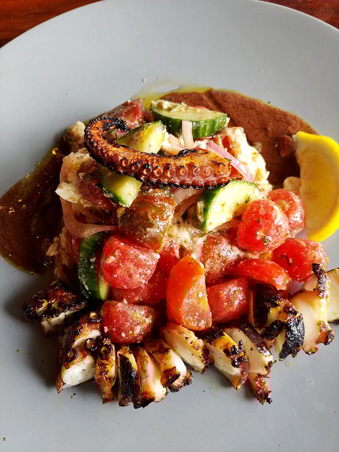 This octopus dish isn't just charred—it's transformed into a Mediterranean masterpiece with vegetables that look like they were harvested this morning.