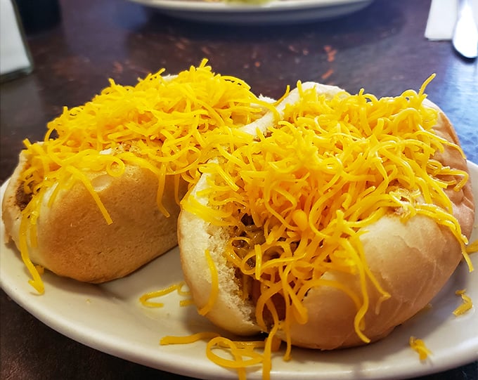 Behold the star attraction – a perfect cheese coney crowned with a mountain of finely shredded cheddar that threatens to avalanche with each delicious bite.