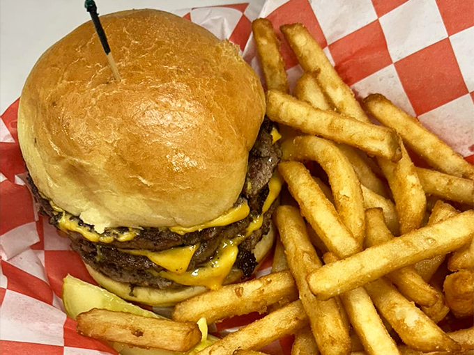 Not all heroes wear capes—some come stacked between buns with melted cheese cascading down the sides, accompanied by golden fries standing at attention.
