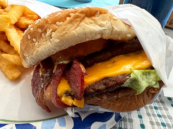 Behold the Super Burger in all its glory—where melted cheese cascades over a perfectly seared patty like a yellow waterfall of happiness.
