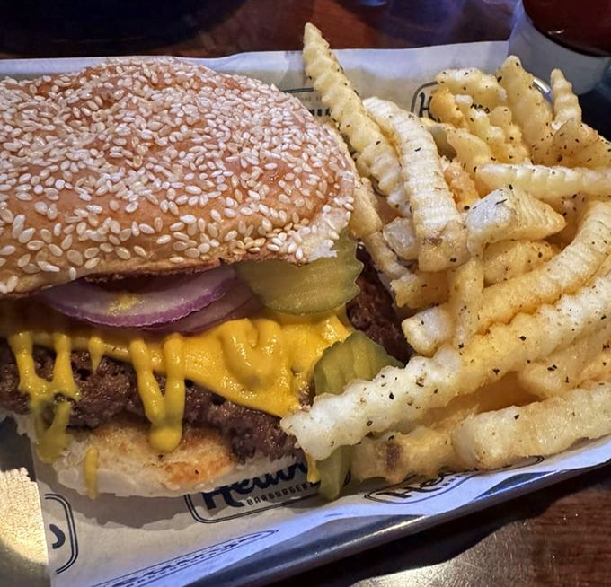 This isn't just a cheeseburger – it's a masterpiece of melty yellow cheese, crisp pickles, and a sesame bun that means business.
