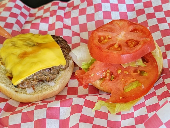 Behold the star of the show: a perfectly melted cheese blanket atop a hand-formed patty, with fresh tomatoes standing by for their supporting role.