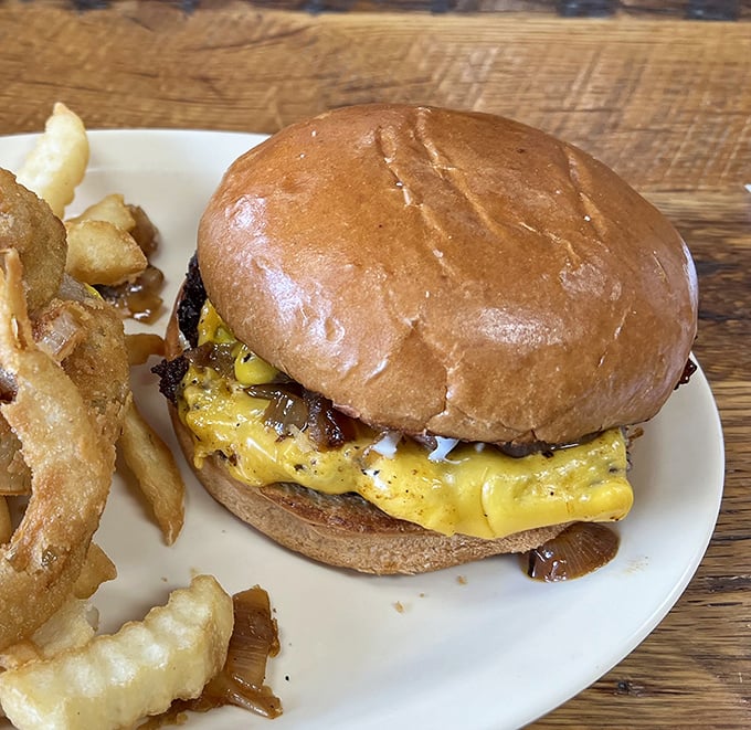 The star of the show in all its glory—melted cheese cascading over a perfectly seared patty on a pillowy bun. This isn't just a burger; it's edible therapy.