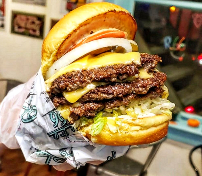 This isn't just a double cheeseburger—it's edible architecture, a towering testament to beef perfection wrapped in wax paper.
