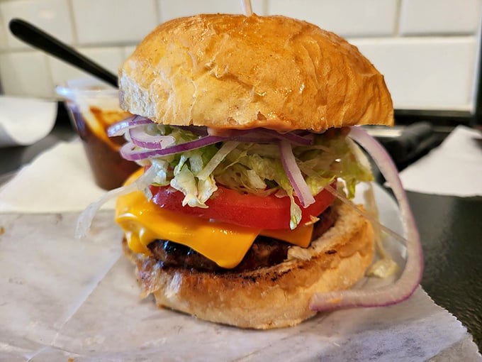 The classic cheeseburger – proof that perfection doesn't require complexity. That golden cheese cascade is what dreams are made of.