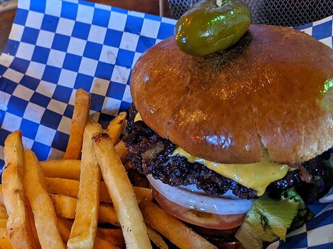 This isn't just a burger—it's edible proof that perfection requires nothing more than quality beef, melted cheese, and a pickle crown fit for Texas royalty.