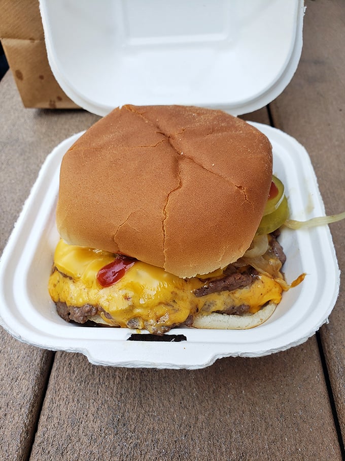 Cheese cascading over perfectly seared patties—this isn't just a cheeseburger, it's Wisconsin's love language translated into edible form.