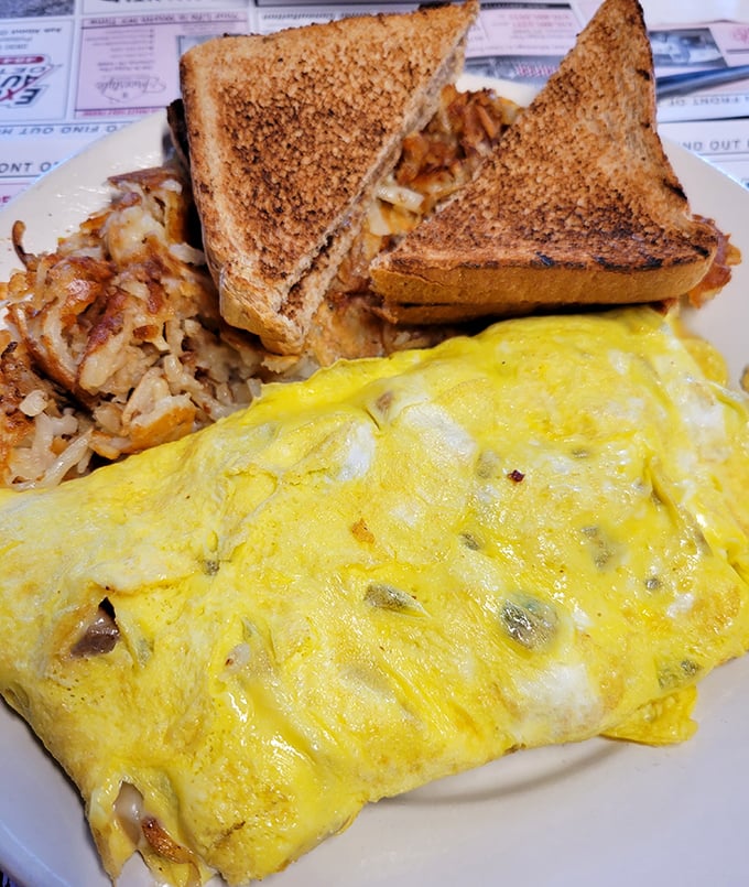 Behold the star attraction – a perfectly executed omelet bursting with cheesesteak filling that bridges Philadelphia tradition with breakfast innovation.