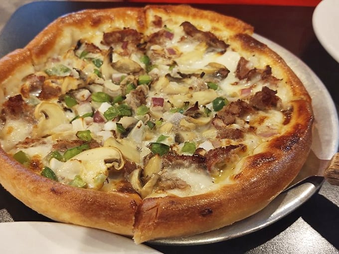Behold the legendary Philly Cheesesteak Pizza in all its glory! Tender steak, sautéed veggies, and cheese that stretches to infinity and beyond.