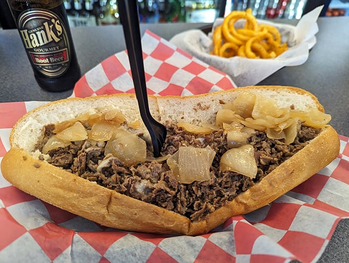 Behold the star of the show – thinly sliced ribeye, perfectly caramelized onions, all nestled in a roll that's both sturdy and yielding. Sandwich architecture at its finest.