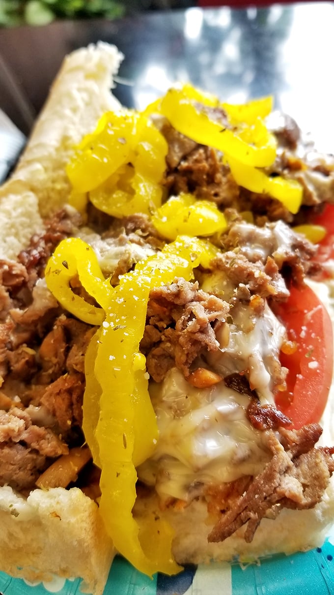 Behold the star of the show! Tender ribeye, melted cheese, and those perfectly sautéed banana peppers create a sandwich worth crossing county lines for.